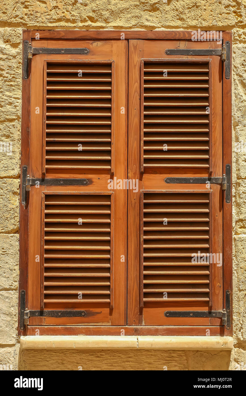 A shuttered window of a historic building with shutters Stock Photo - Alamy