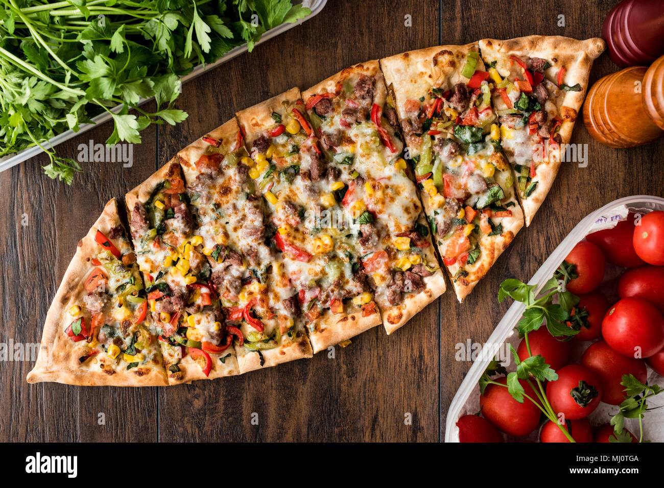 Turkish Pide with meat and vegetables on a wooden surface Stock Photo ...