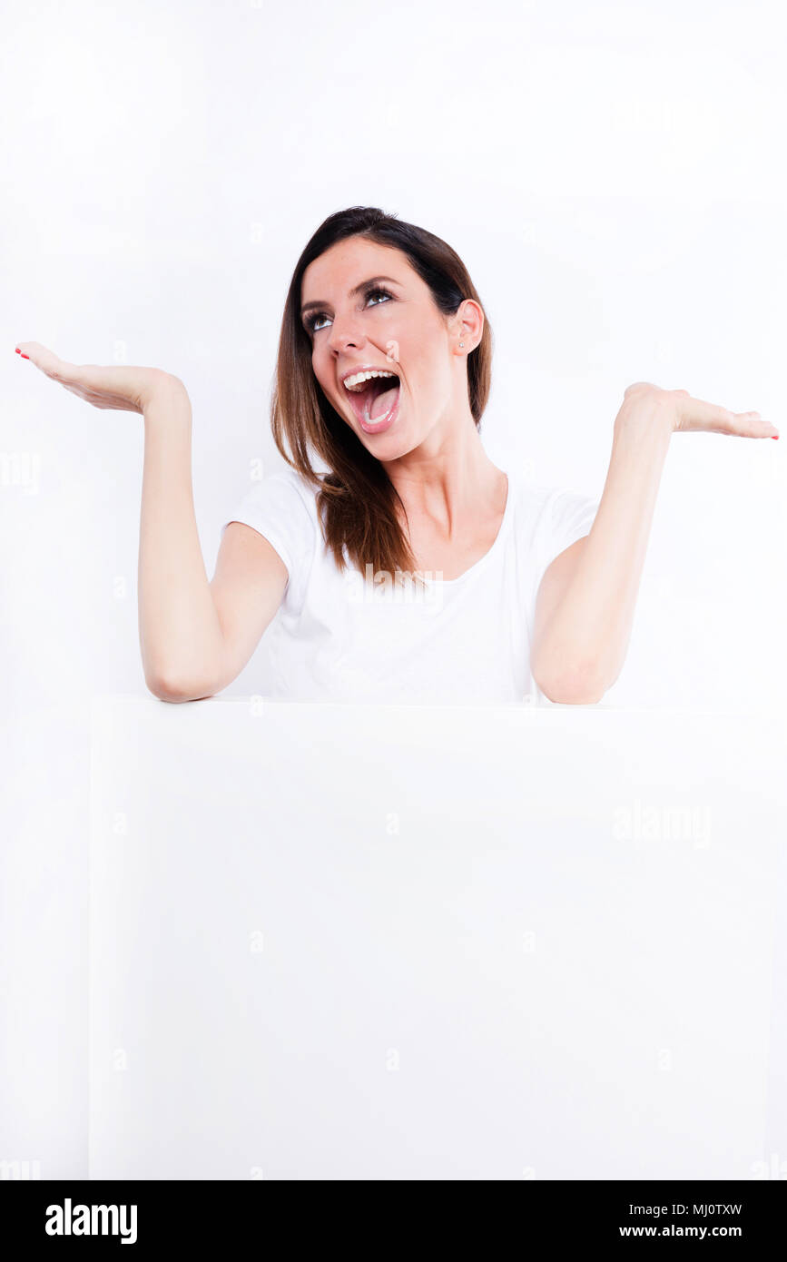 A beautiful young woman standing with a white signboard and feeling ...