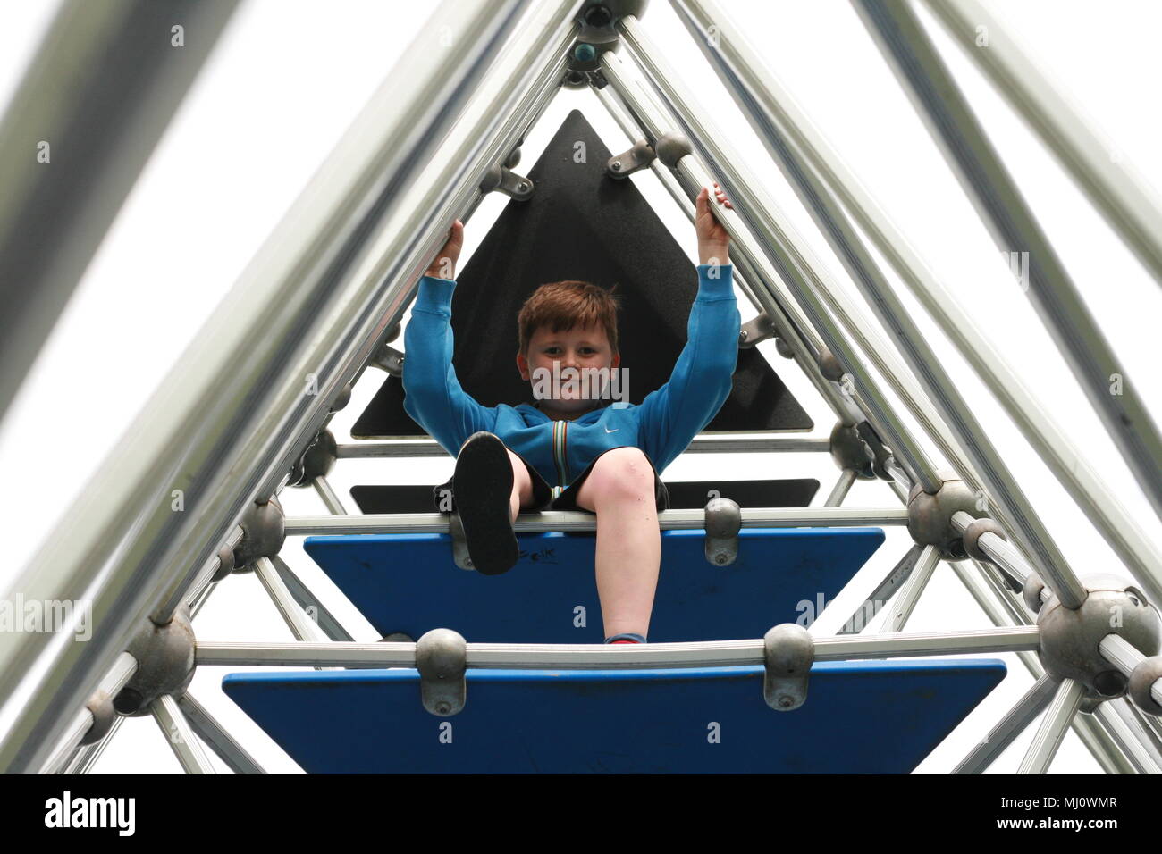 Boy playing on playground Stock Photo - Alamy
