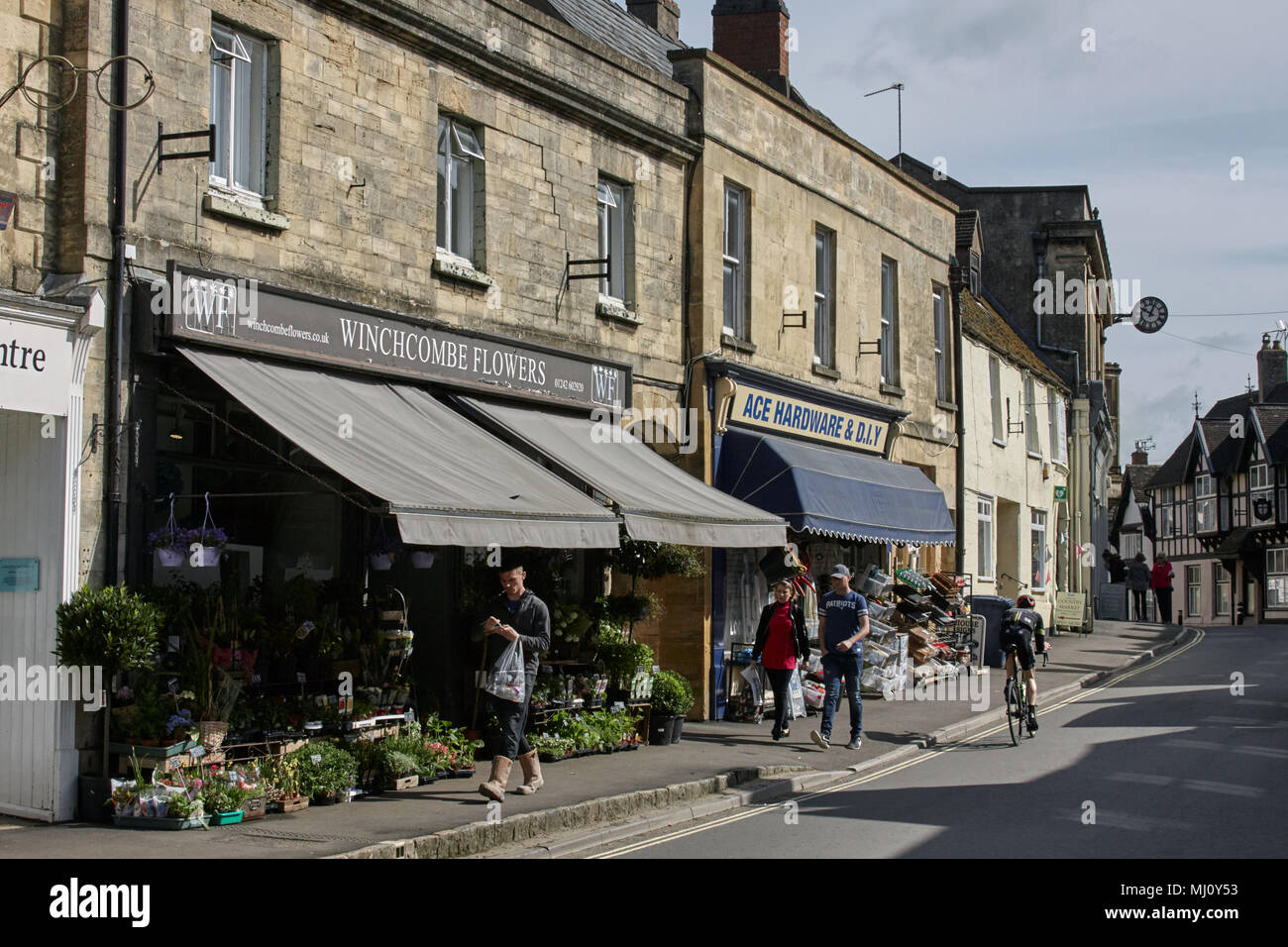Shops and pedestrians / shoppers on the high street of the Cotswold ...