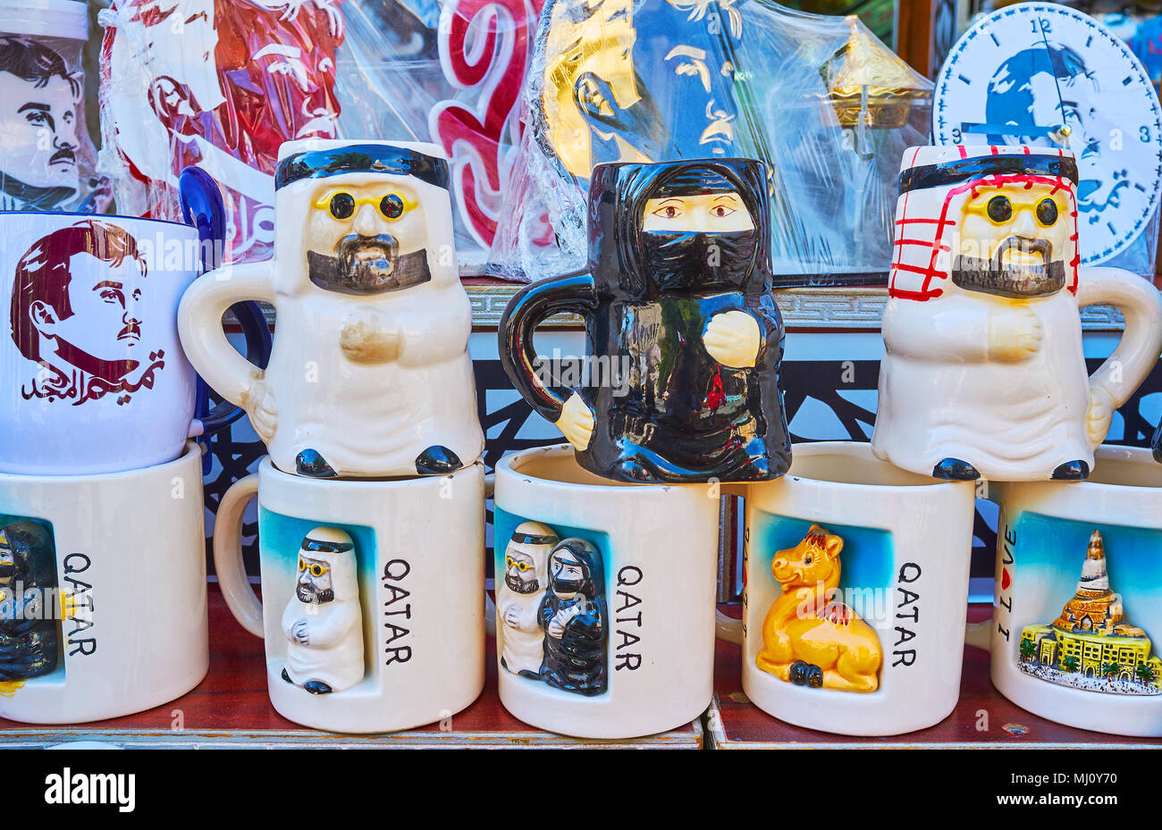 DOHA, QATAR - FEBRUARY 13, 2018: The cups with figurines of Arabic male ...