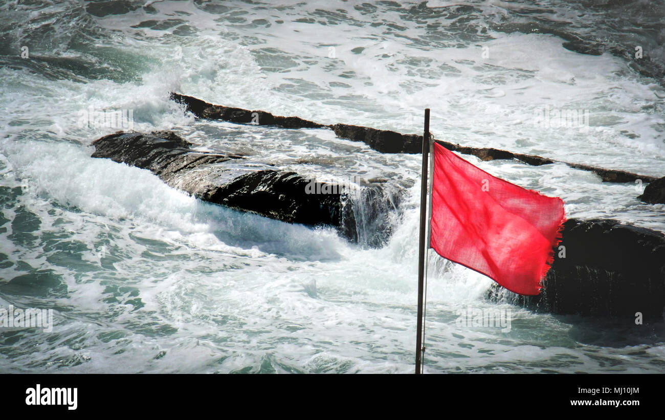 red flag sea rocks rough storm gale wind alert background Stock Photo ...
