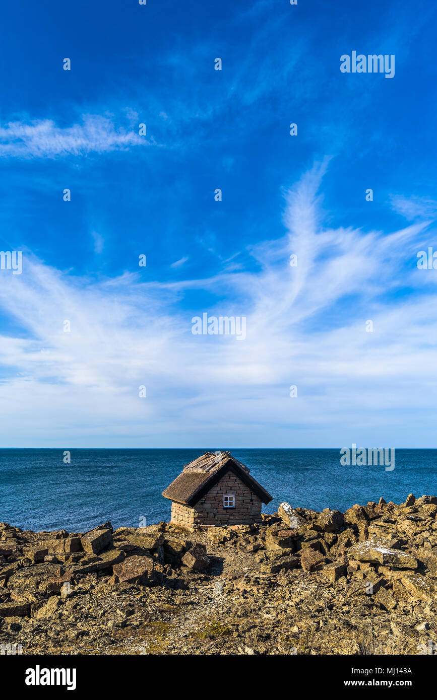 Small limestone cabin on the edge of a coastal limestone cliff on the ...