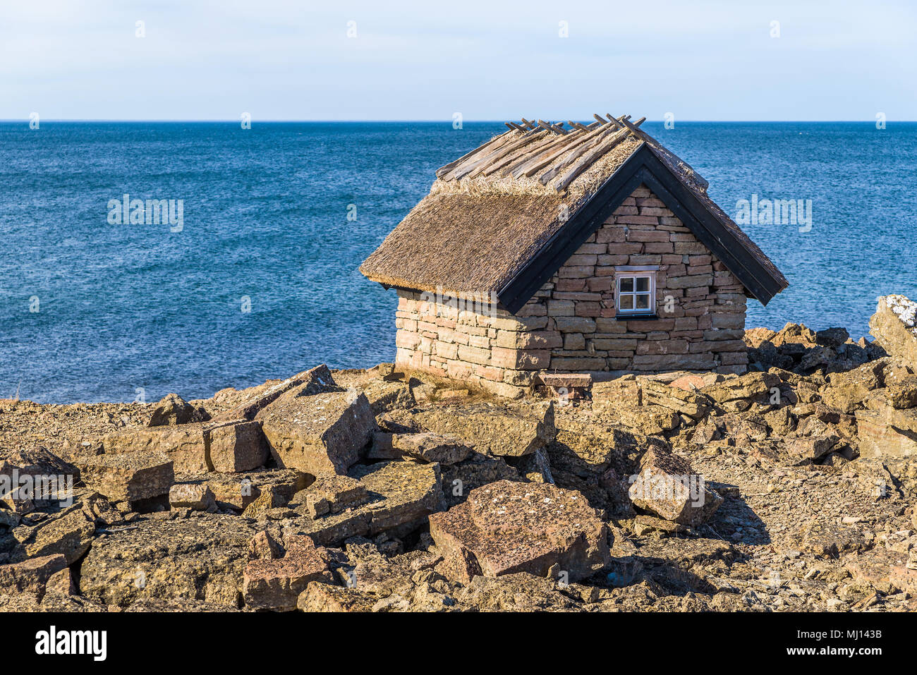 Small limestone cabin on the edge of a coastal limestone cliff on the ...