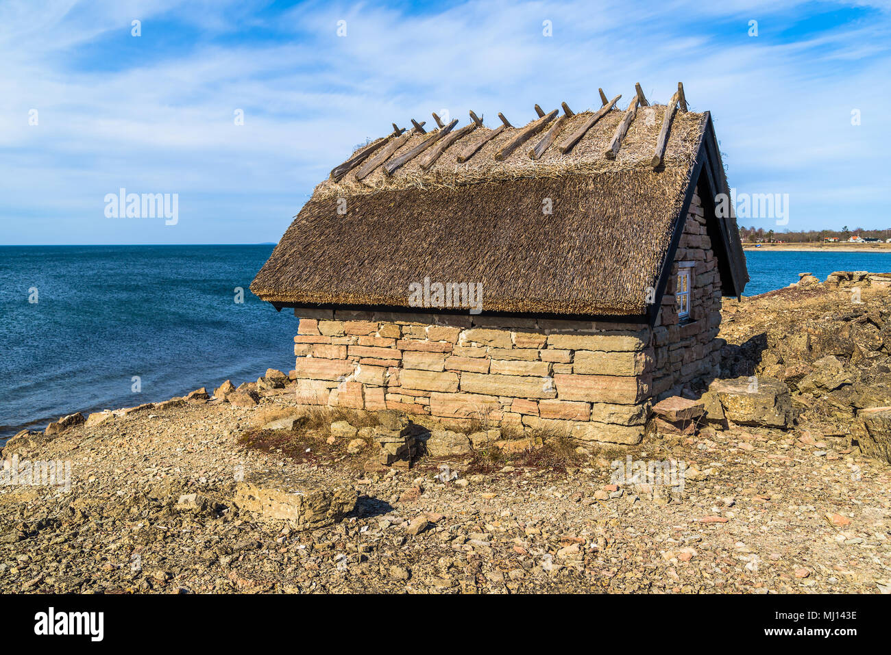 Small limestone cabin on the edge of a coastal limestone cliff on the ...