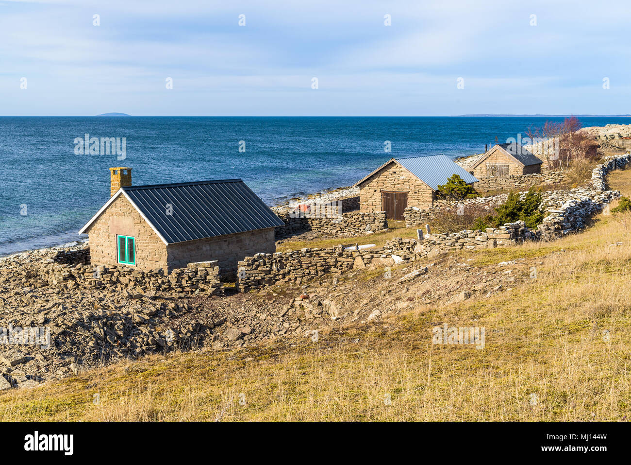 Small limestone fishing cabins in a row along the shore. Limestone ...