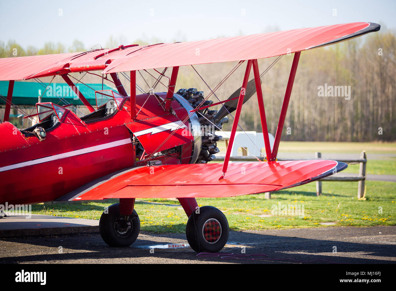 Vintage red plane ready to fly on the field at day Stock Photo - Alamy