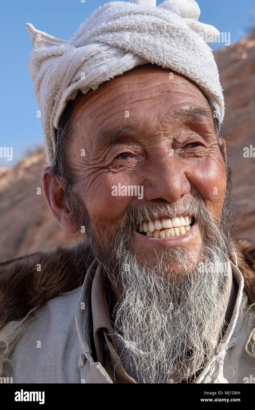 Smiling Chinese elder with traditional garb Stock Photo - Alamy