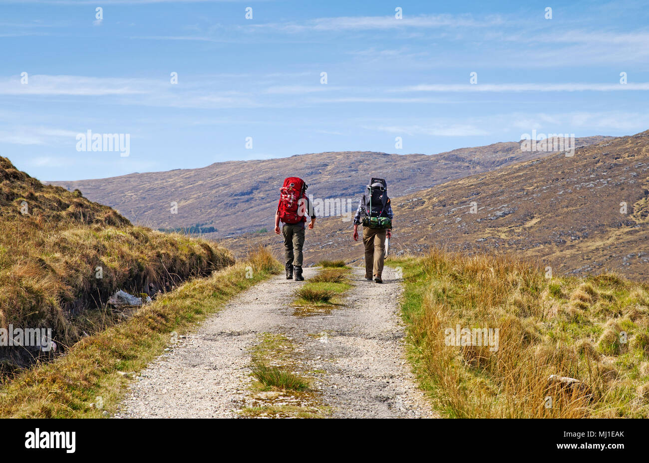 Two hillwalkers on remote track in mountainous area near Achfary on ...