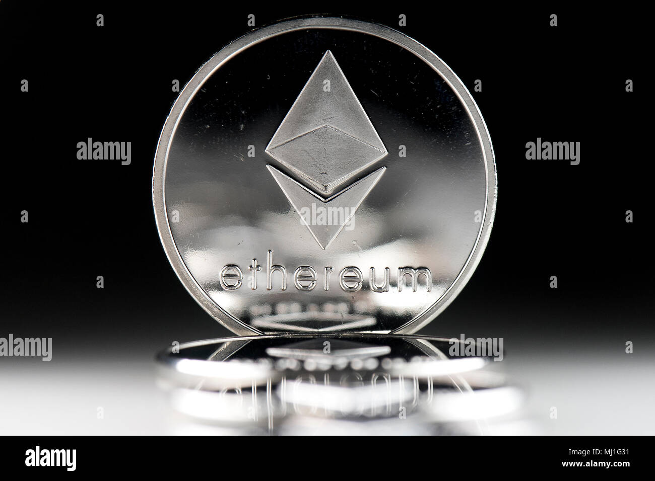 Etherium "coins" are photographed to represent cryptocurrency Etherium ...