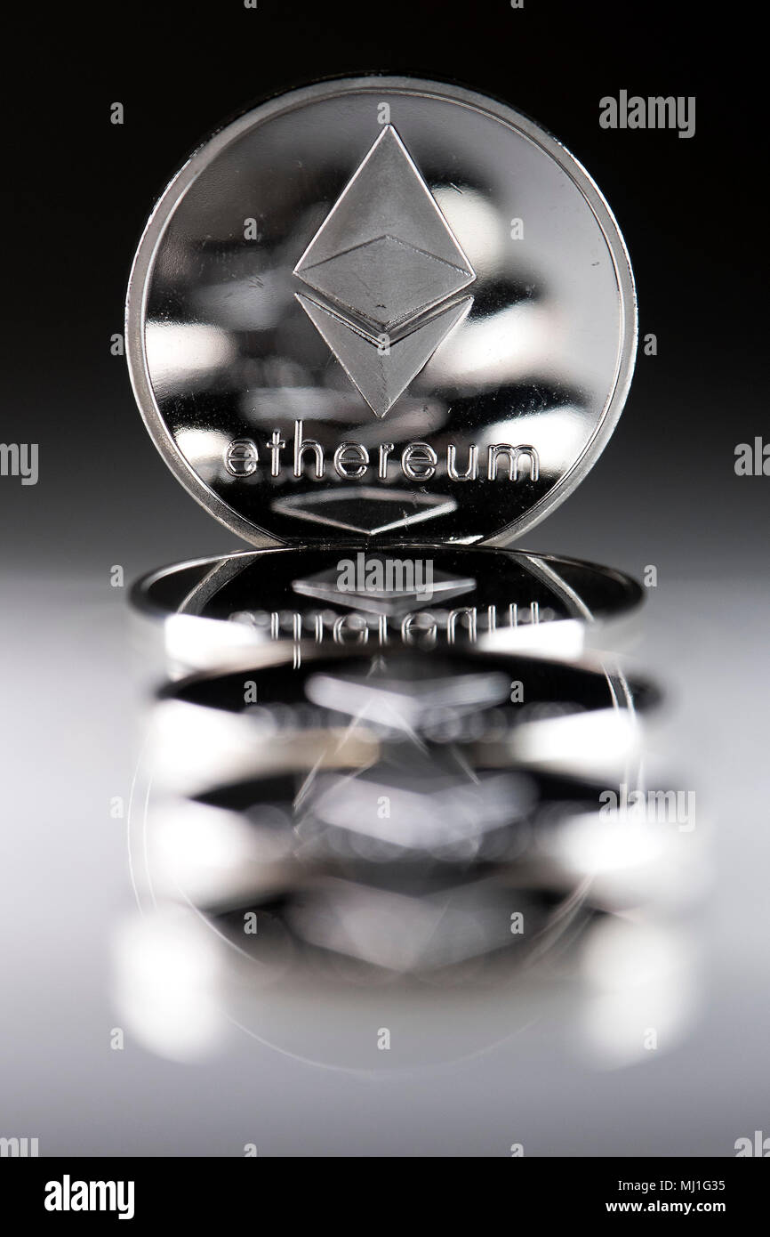 Etherium "coins" are photographed to represent cryptocurrency Etherium ...
