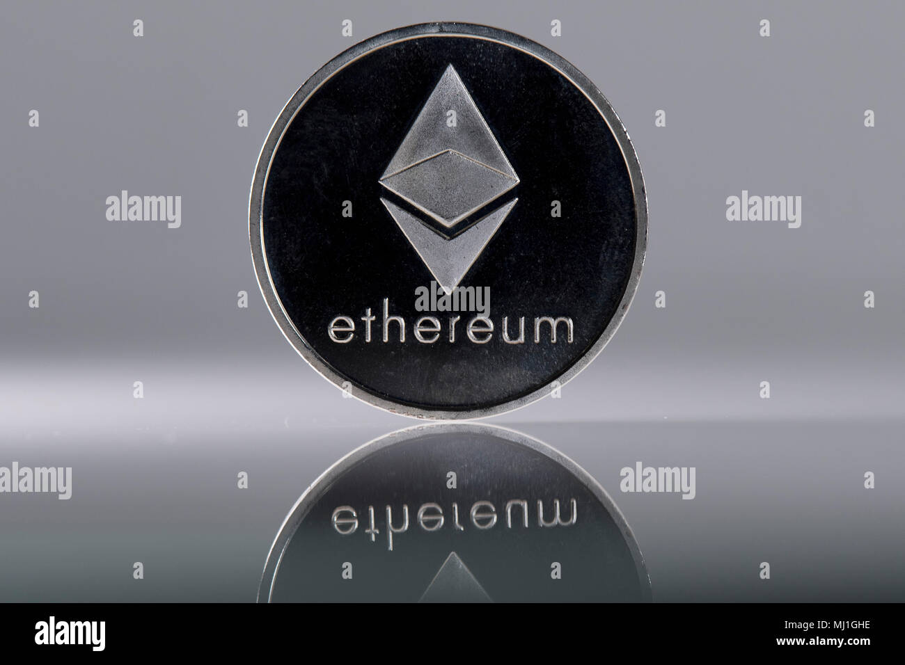 Etherium "coins" are photographed to represent cryptocurrency Etherium ...