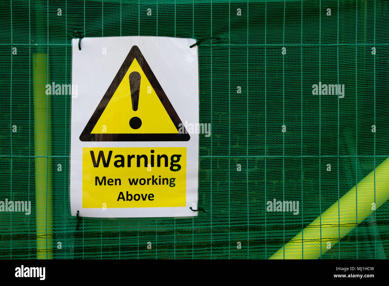Warning men working above notice on a building or construction site ...