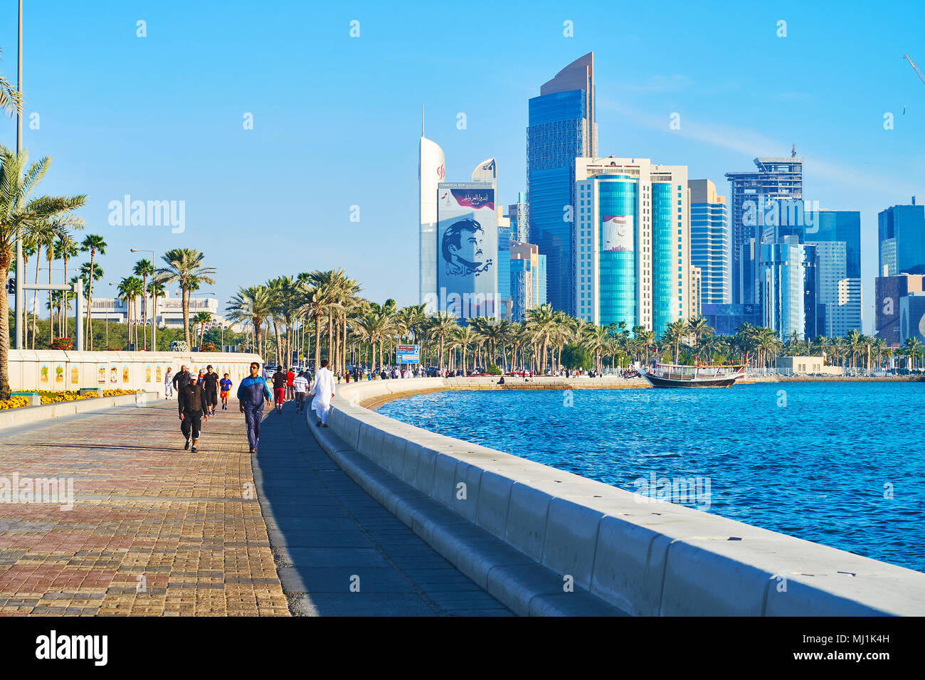 DOHA, QATAR - FEBRUARY 13, 2018: The Corniche promenade is full of ...