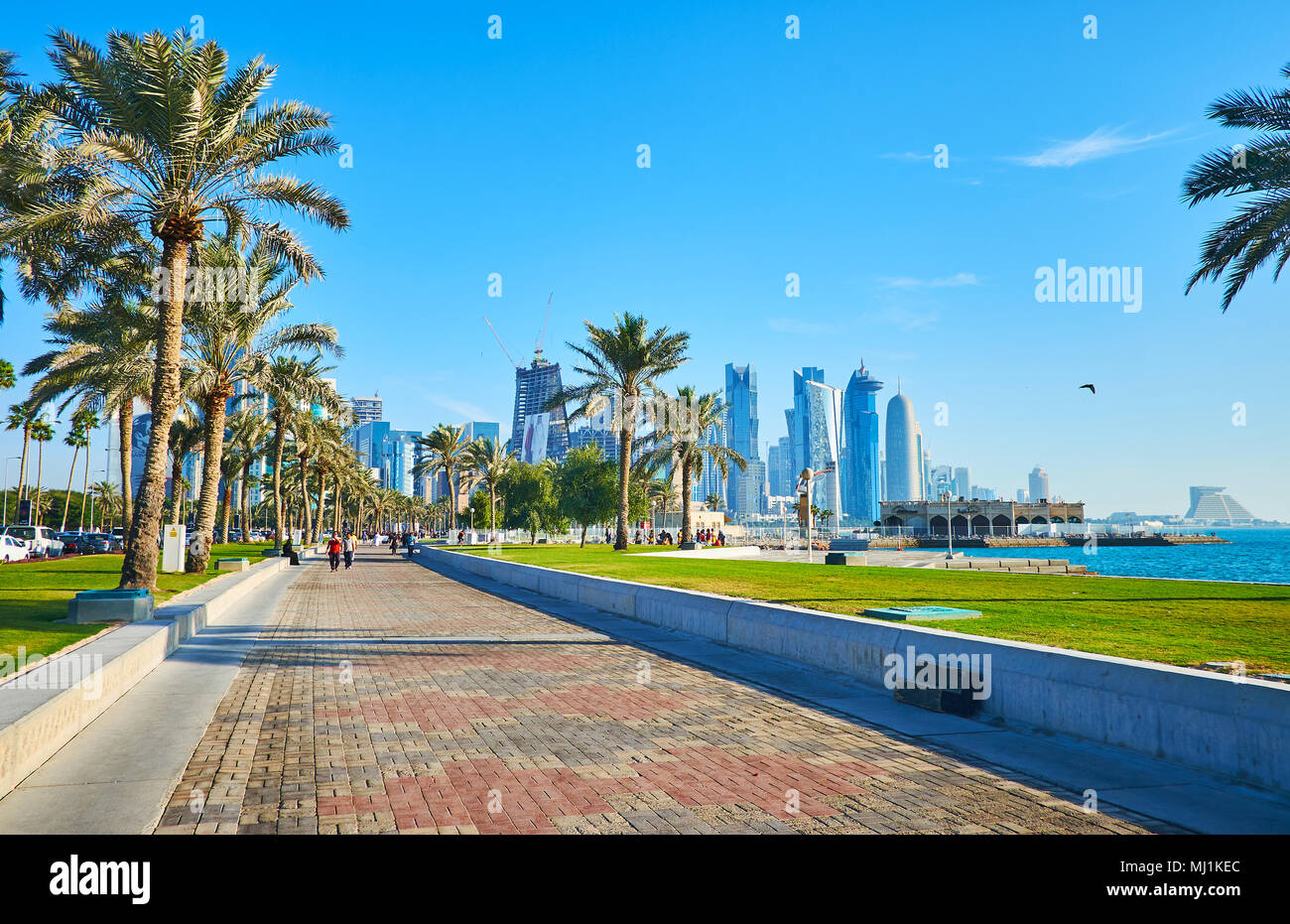 The beautiful seaside promenade with lush palms and juicy lawn ...