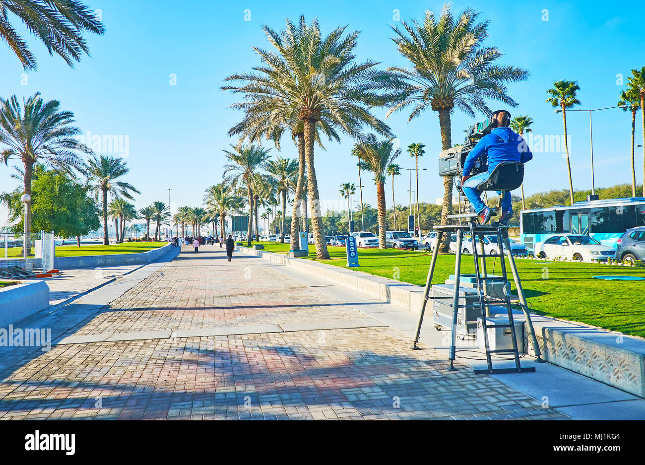 DOHA, QATAR - FEBRUARY 13, 2018: Cameraman conducts live TV broadcast ...