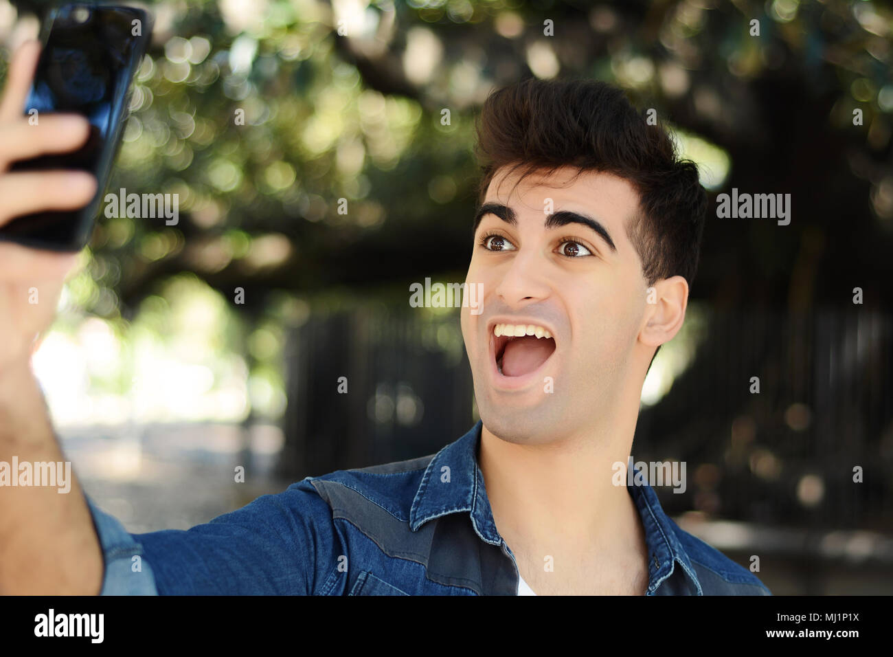 Young handsome tourist man taking hi-res stock photography and images ...