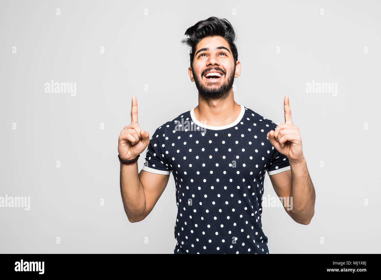 Indian man looking and pointing up his finger Stock Photo - Alamy