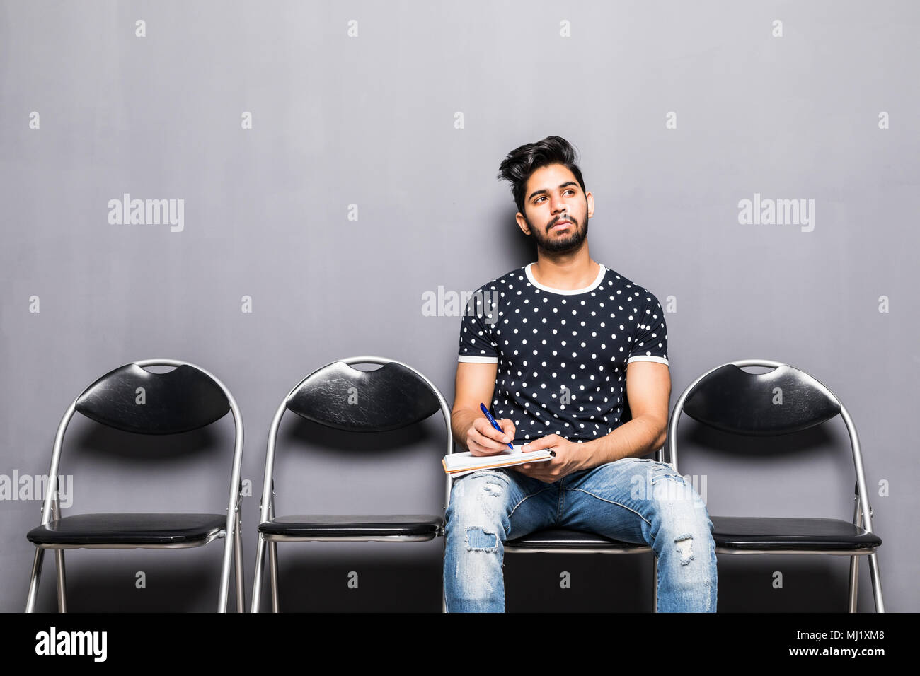 Young man waiting for job interview in reception hall Stock Photo - Alamy