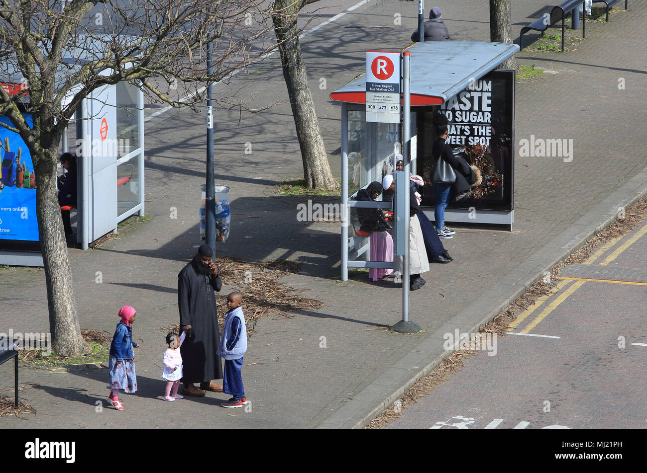 People waiting at the bus stop in diverse and multicultural Canning ...