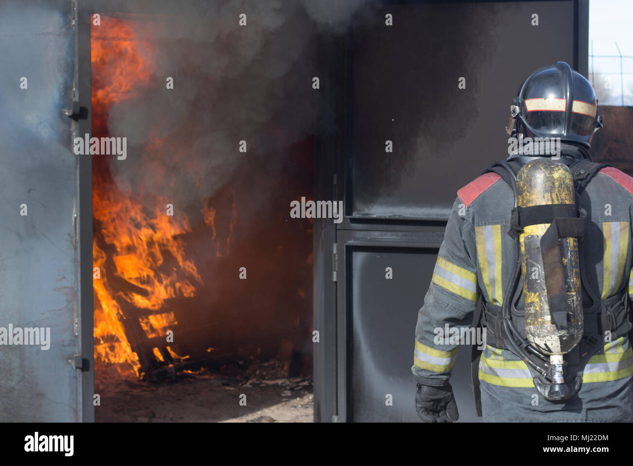 Firefighter putting out fire training station extinguisher backdraft ...
