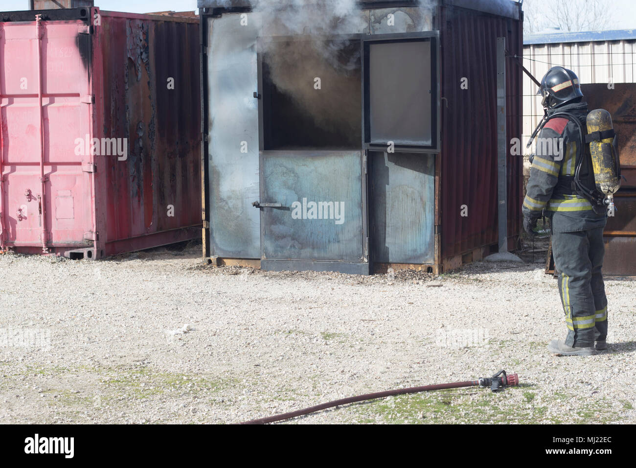 Firefighter putting out fire training station extinguisher backdraft ...