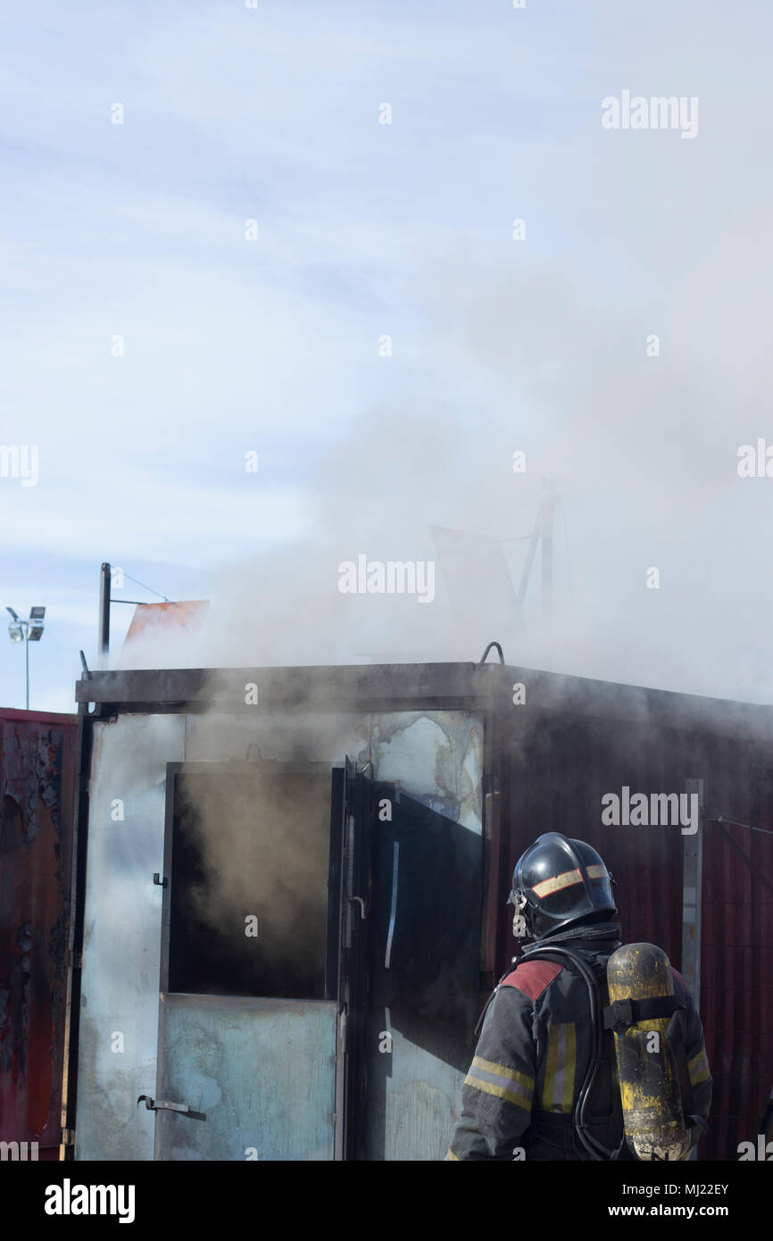 Firefighter putting out fire training station extinguisher backdraft ...