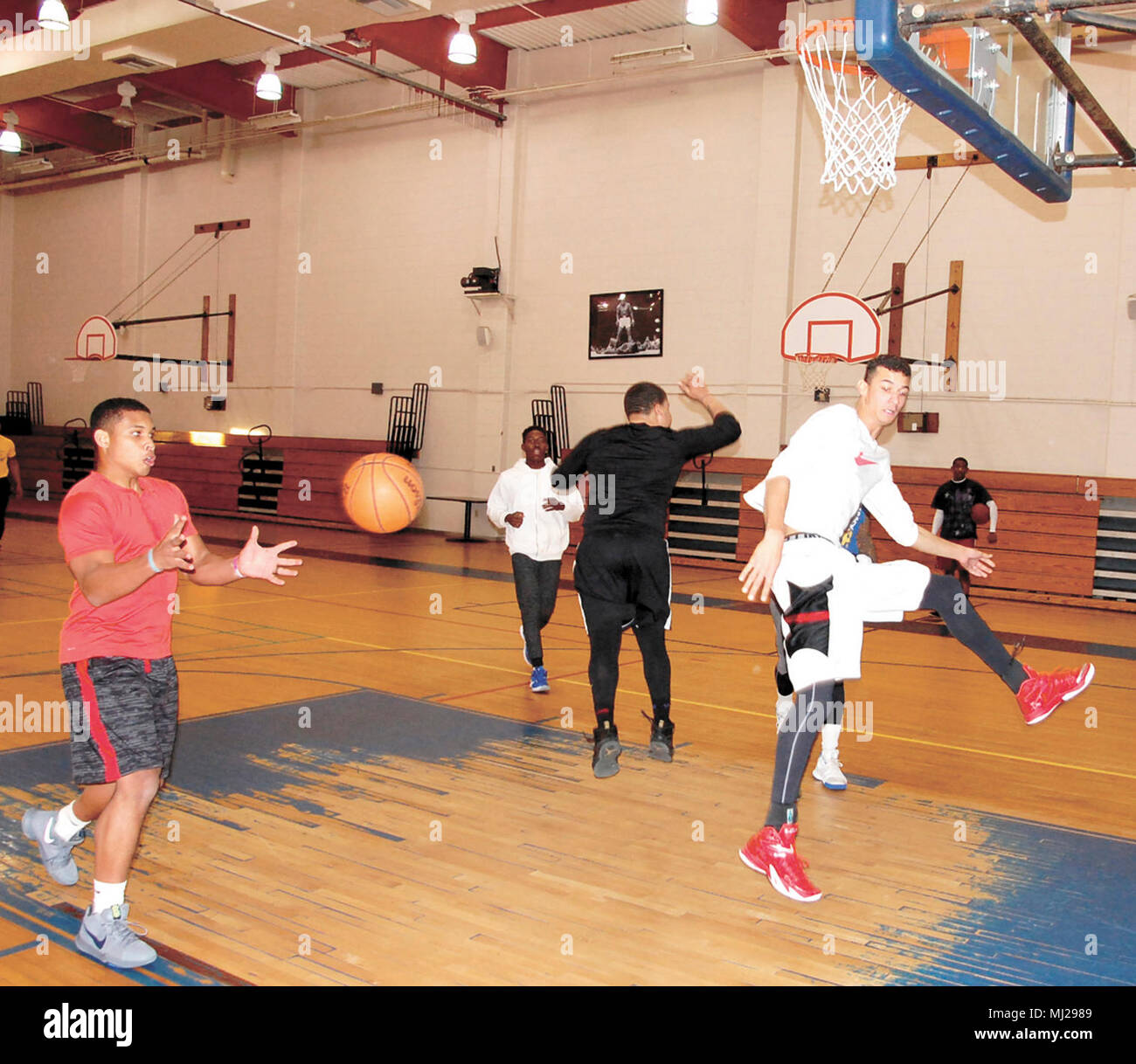 A group of friends enjoy a pickup basketball game. Image collection ...