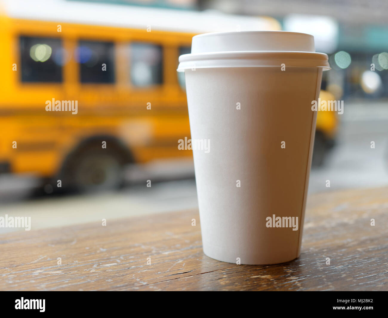 Cup of coffee blank against yellow school bus usa Stock Photo - Alamy