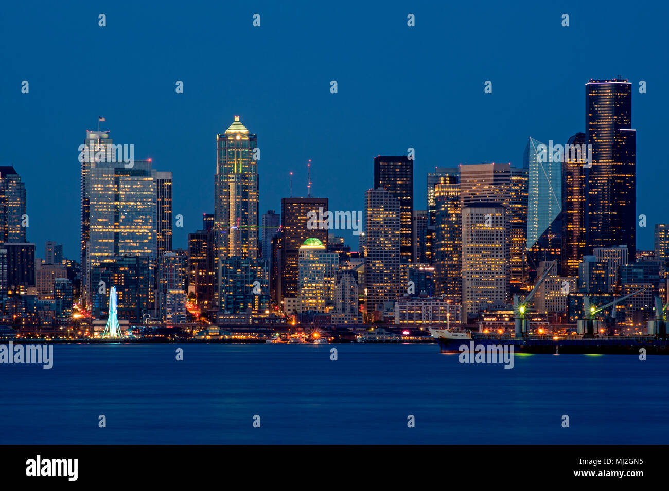 Retro image of Seattle skyline at sunset twilight along Elliott Bay ...