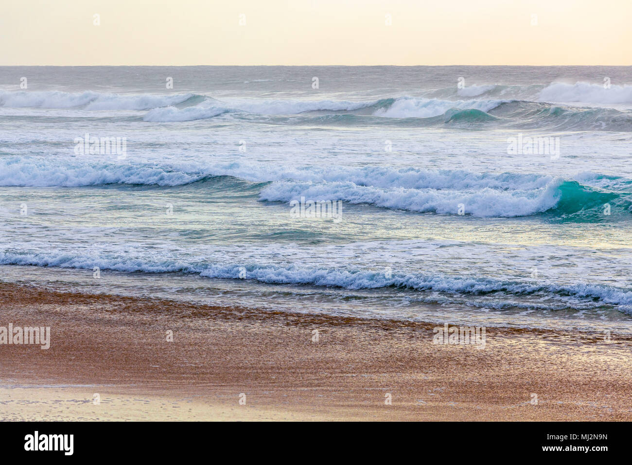 Ocean waves and beach sand at sunset - tranquil landscape Stock Photo ...