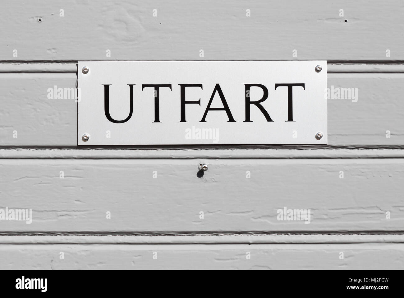 An exit signage in Swedish on grey a garage port Stock Photo - Alamy