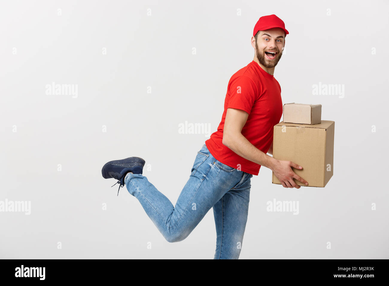 Delivery Concept - Handsome caucasian delivery man rush running for ...