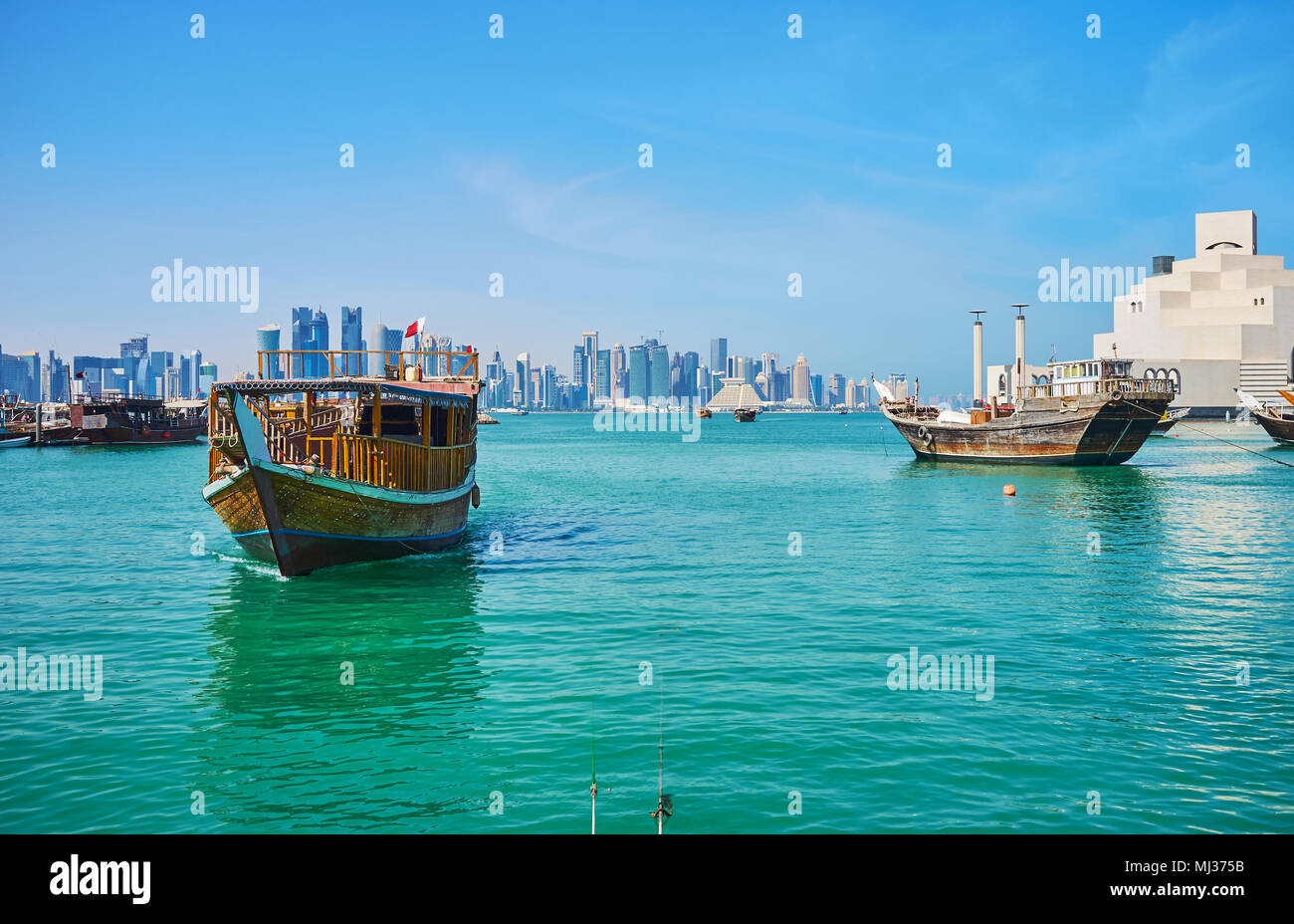 The dhow boat is floating to the harbor after the trip along the coast ...