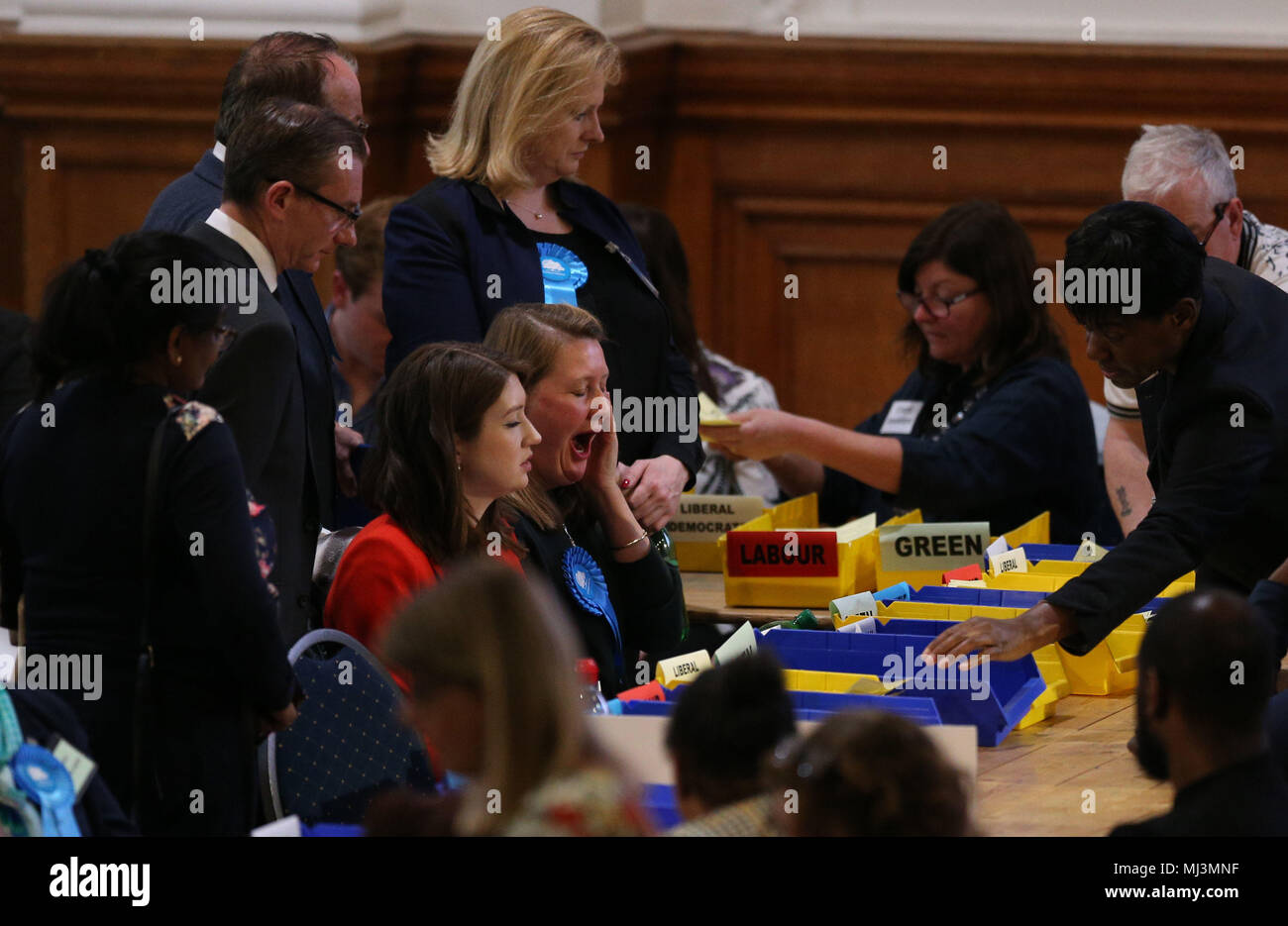 Candidates and their associates watch count volunteers sort ballot ...