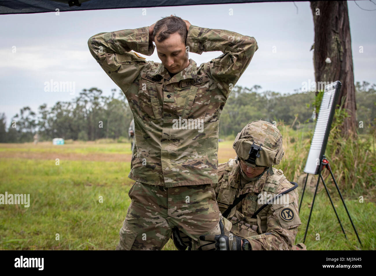 Sgt. Jeffrey O. Embry of the 411th Engineer Battalion searches a ...