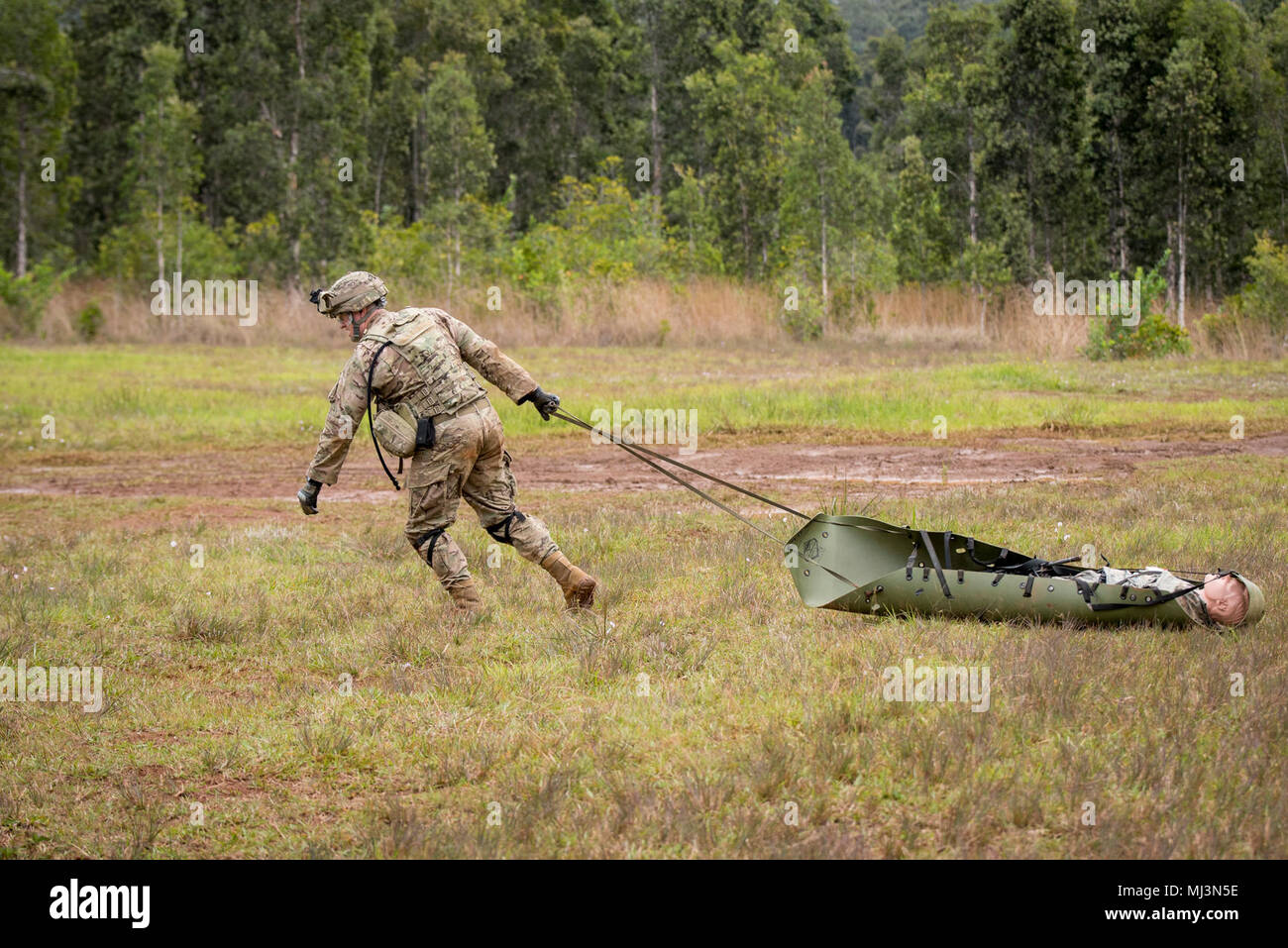 Sgt. Jeffrey O. Embry of the 411th Engineer Battalion drags the ...