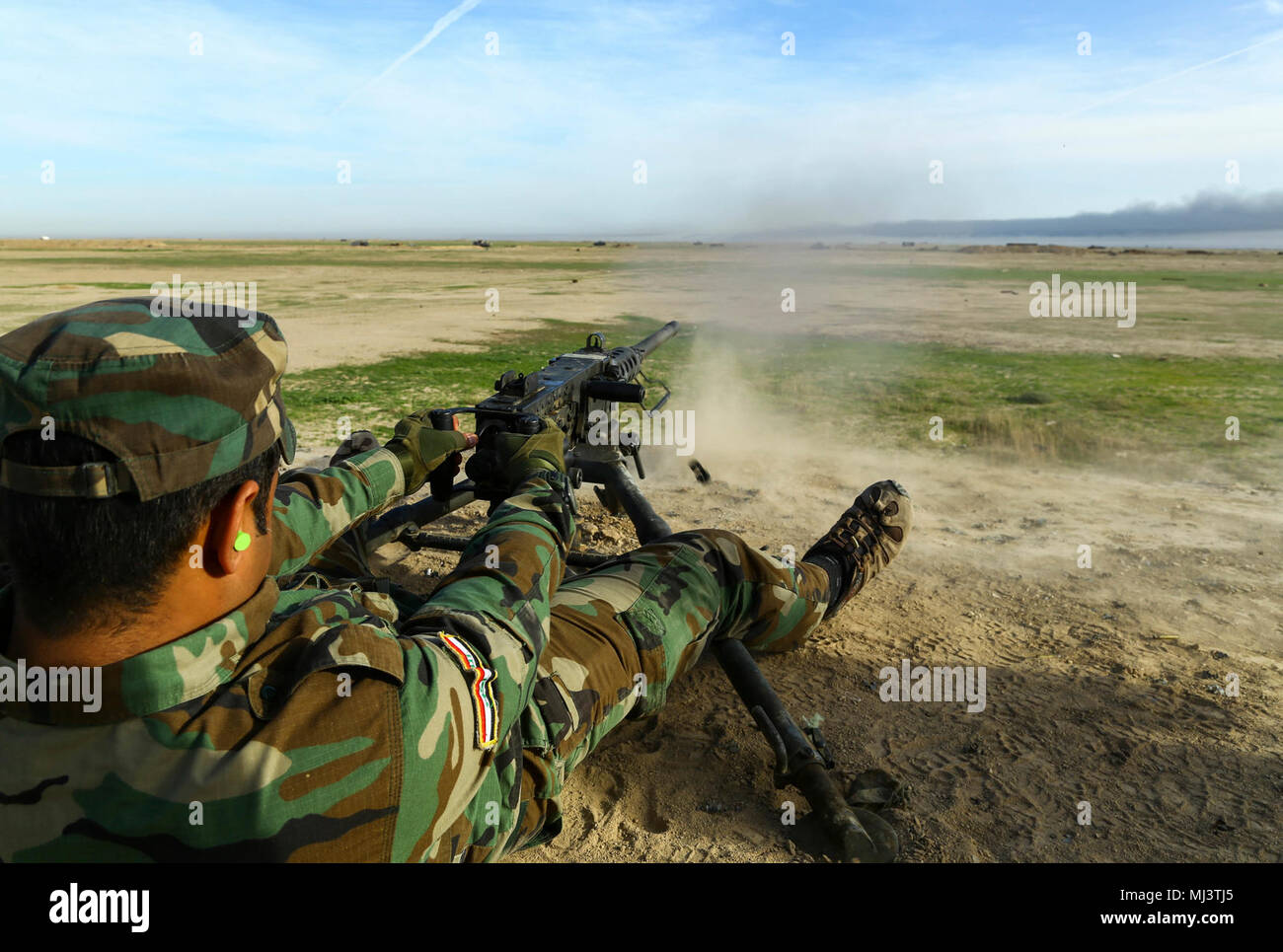 An Iraqi soldier fires a .50-caliber machine gun during the heavy ...