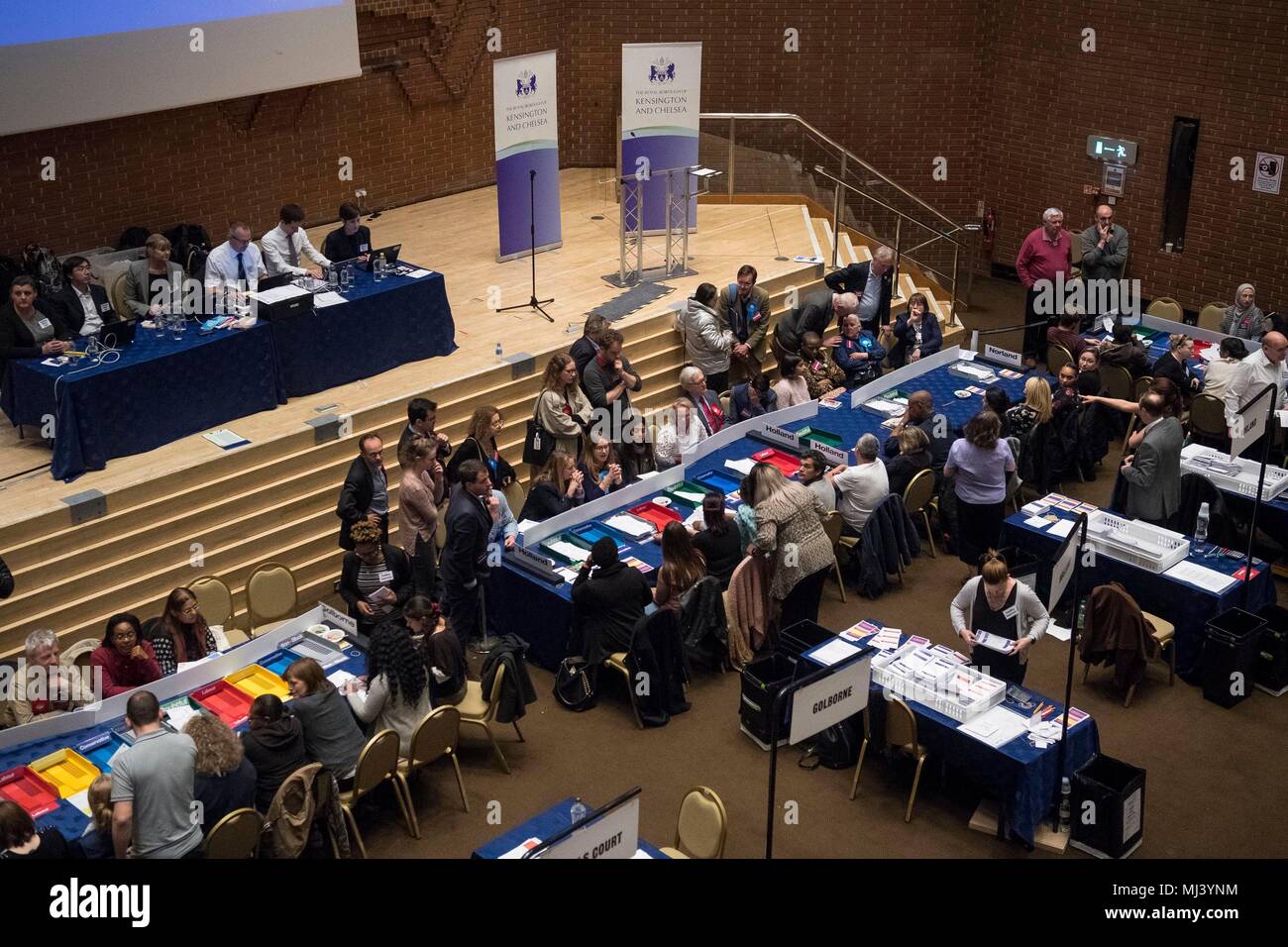 Count volunteers sort ballot papers at Kensington Town Hall, London as ...