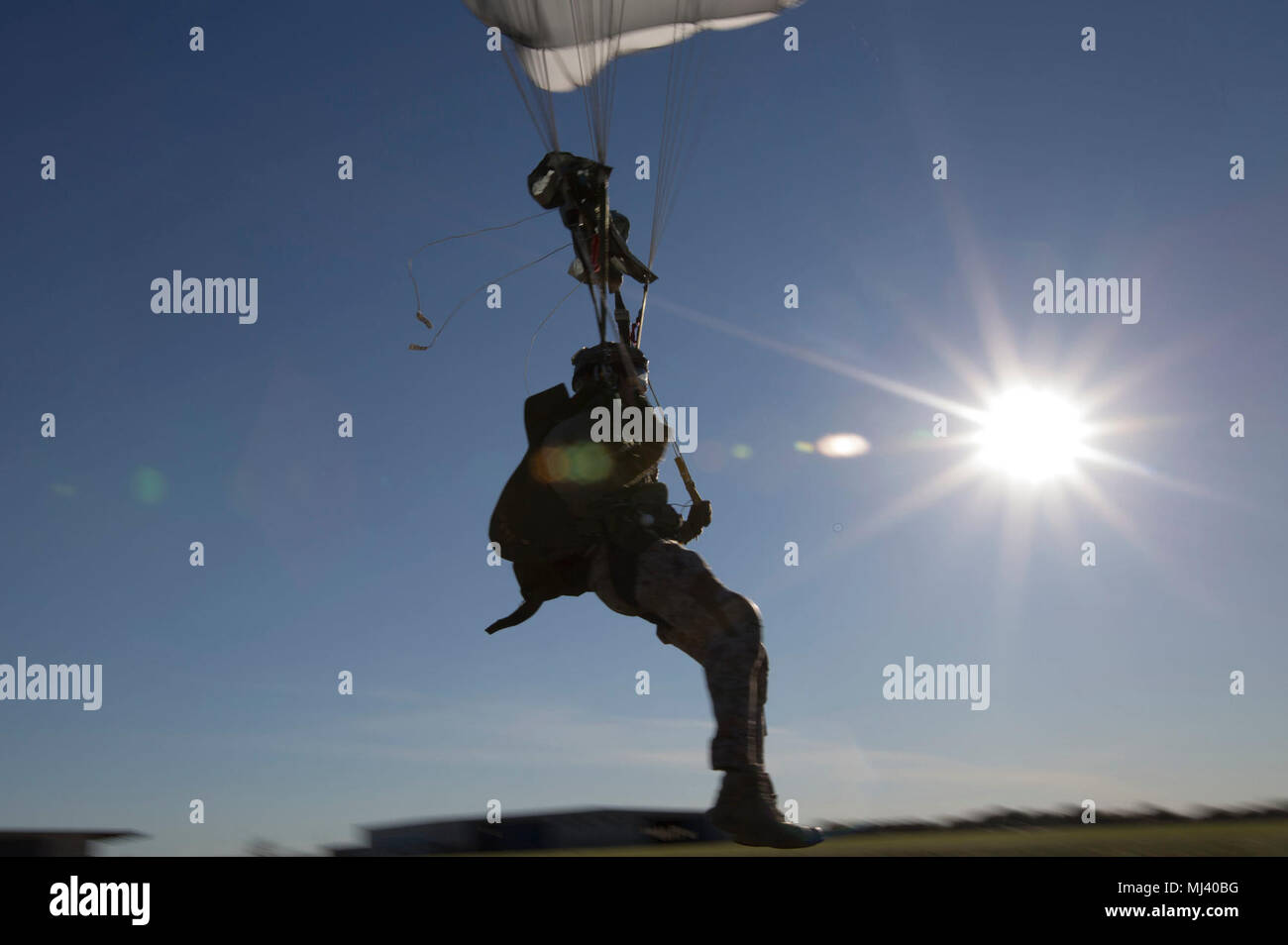 A Reconnaissance Marine glides through the air during parachute jumps ...