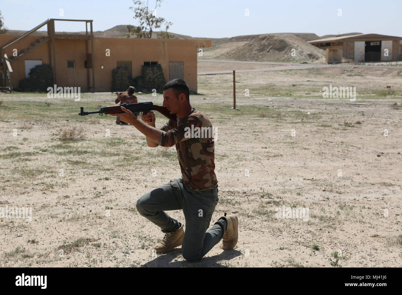An Iraqi member with the Desert Battalion pulls security during a ...