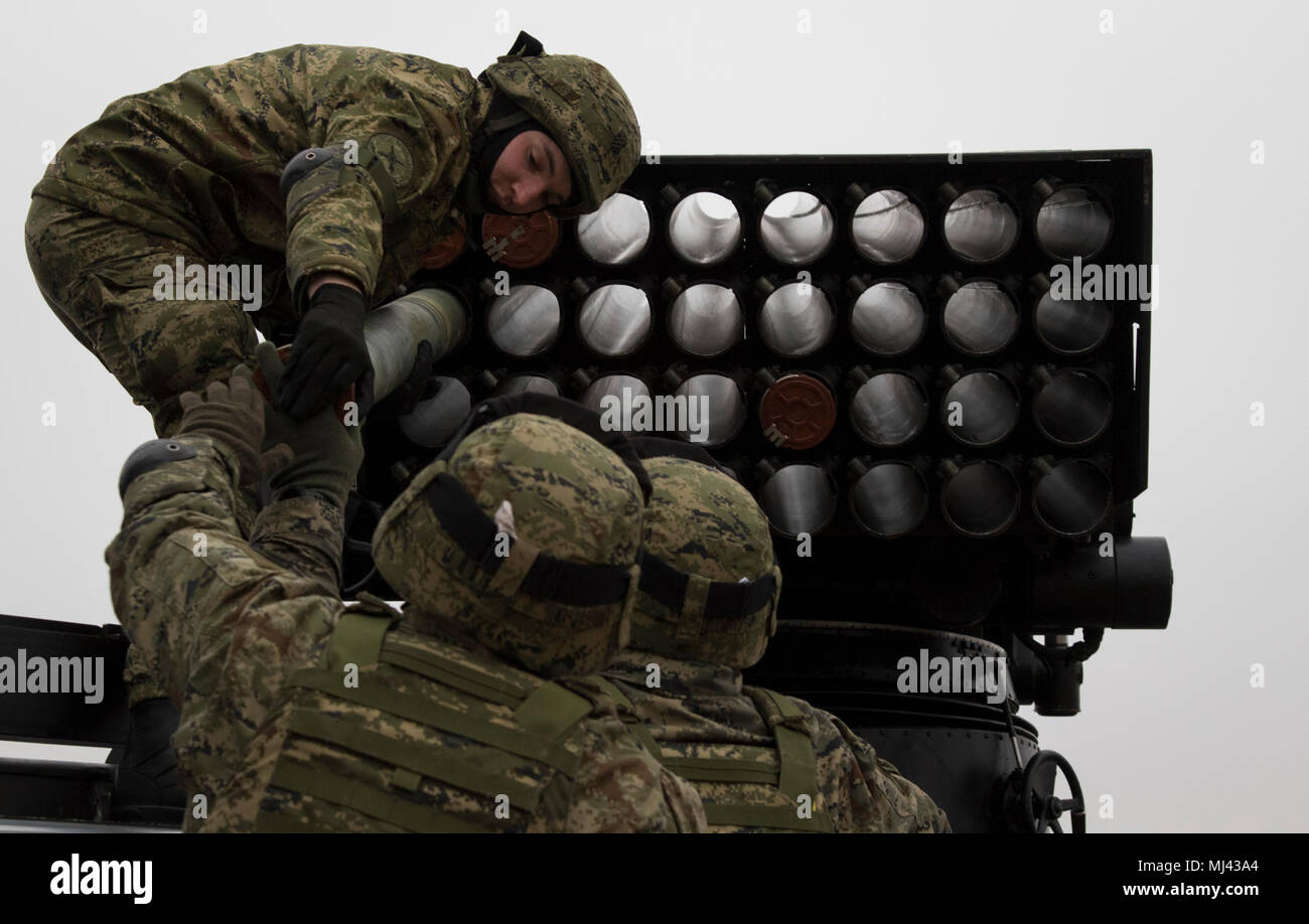 Croatian artillery soldiers assigned to Volcano Battery load a rocket ...