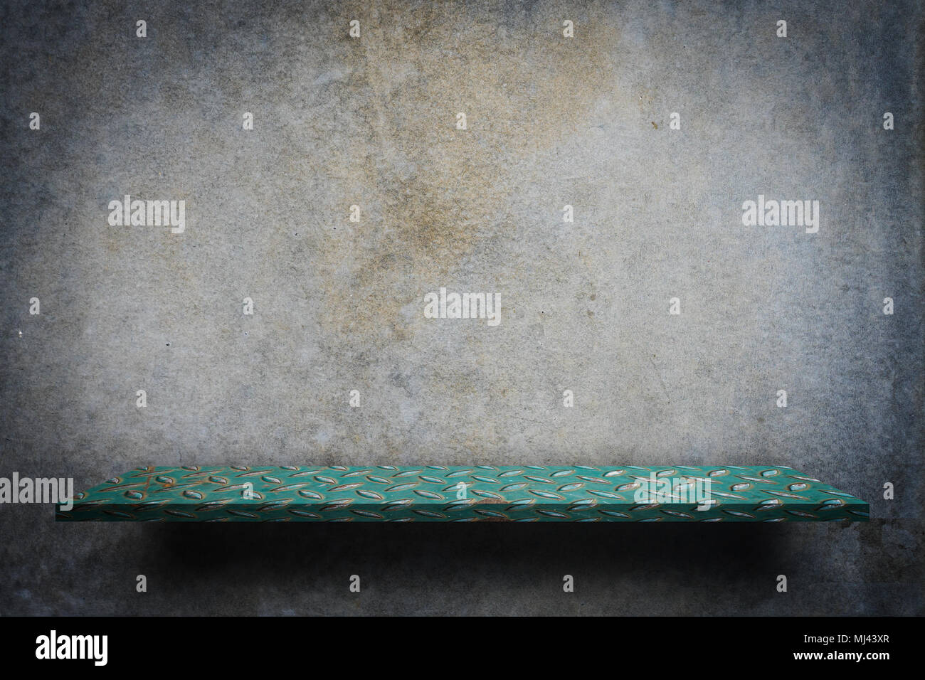 Green metal shelf display counter on grungy wall Stock Photo - Alamy