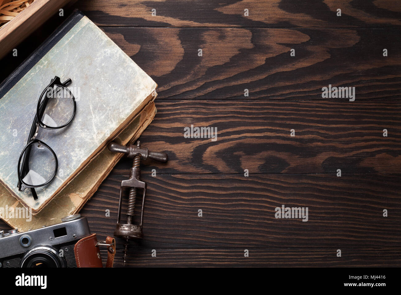 Retro table with vintage items. Camera, books, wine bottle. Top view ...