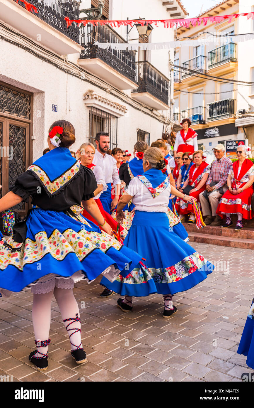 NERJA, SPAIN - MAY 04, 2018 people participating in a traditional folk ...
