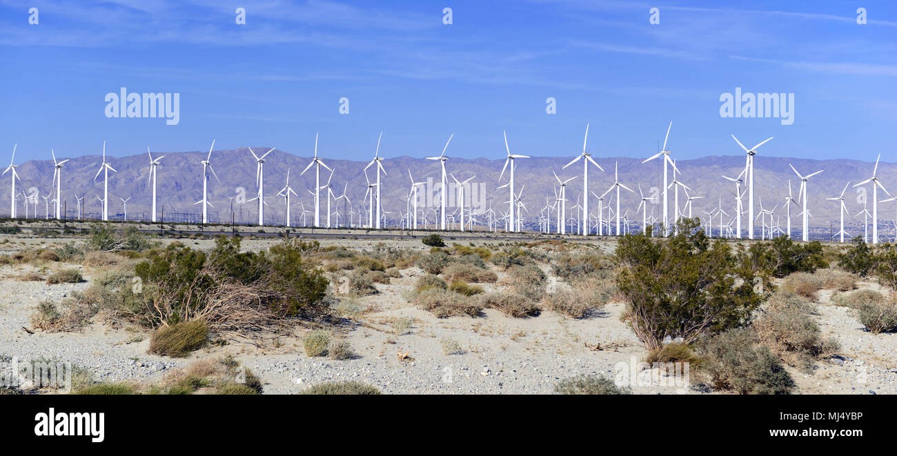 Wind turbines creating renewable energy on windfarm in desert with ...
