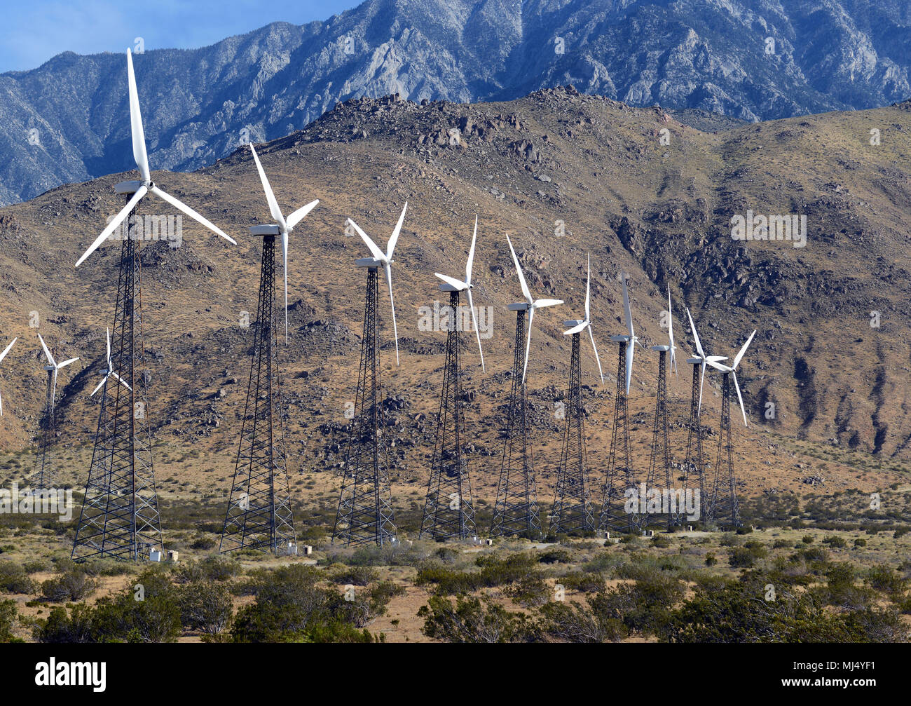 Wind turbines creating renewable energy on windfarm in desert with ...