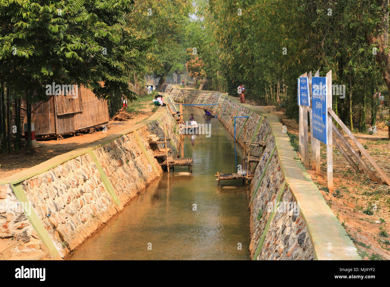 Laundry washing platforms in use along the steep channel walls of an ...