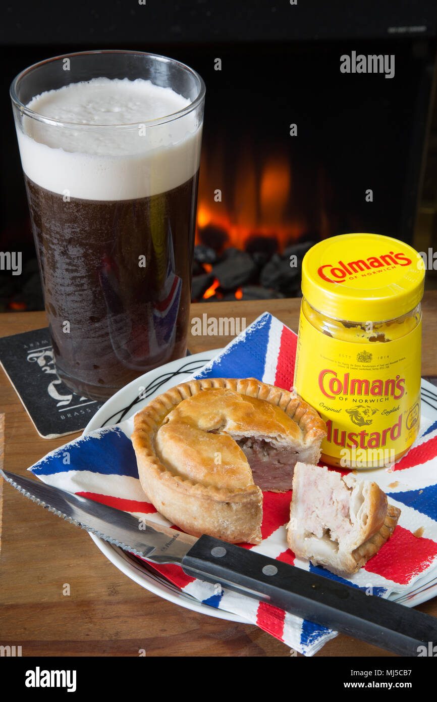 An English pub classic snack of Pork pie with Coleman's English mustard ...